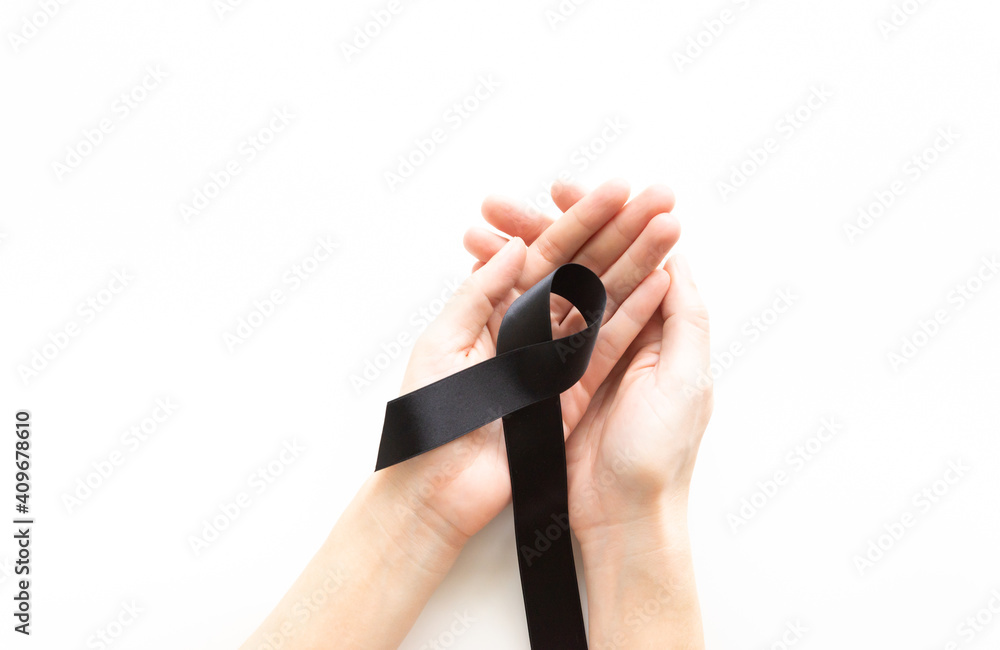 Two woman hands and black ribbon showing symbol of remembrance or ...