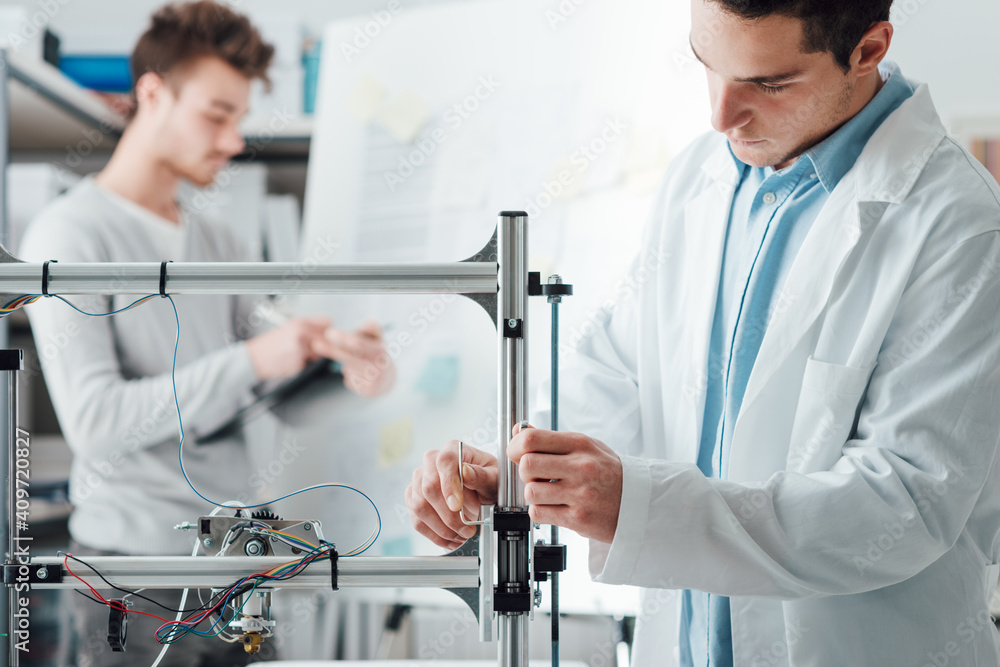 Engineers in the lab using a 3D printer Stock Photo | Adobe Stock