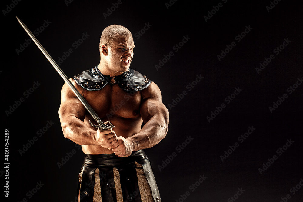 Severe barbarian in leather costume with sword. Portrait of balded ...
