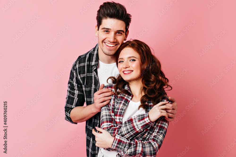 Studio shot of romantic couple posing with smile. Front view of girl ...