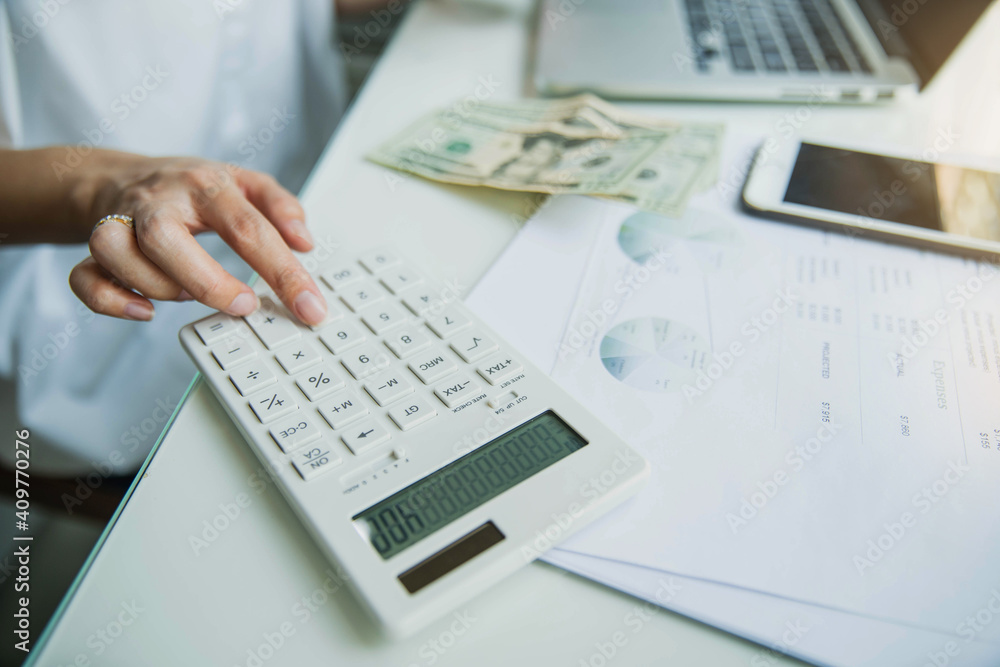 Hand woman doing finances and calculate on desk about cost at home ...