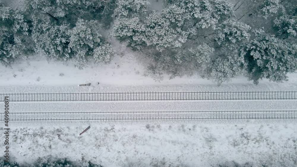 Train passenger transport moving forward on railways in winter snowfall ...