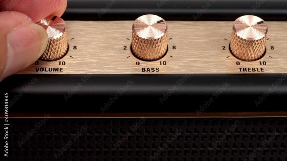 Hand adjusting volume control.Use hand to adjust the volume at the ...