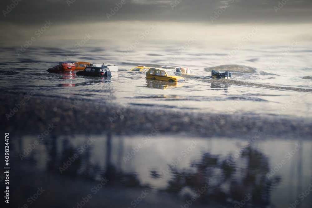 Scene of cars (miniature, toy model ) in flood from natural disasters ...