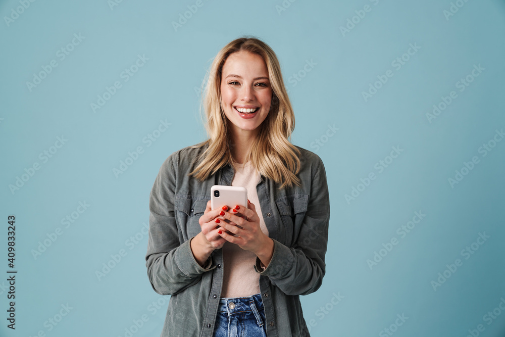 Cheerful beautiful blonde girl smiling and using mobile phone Stock ...