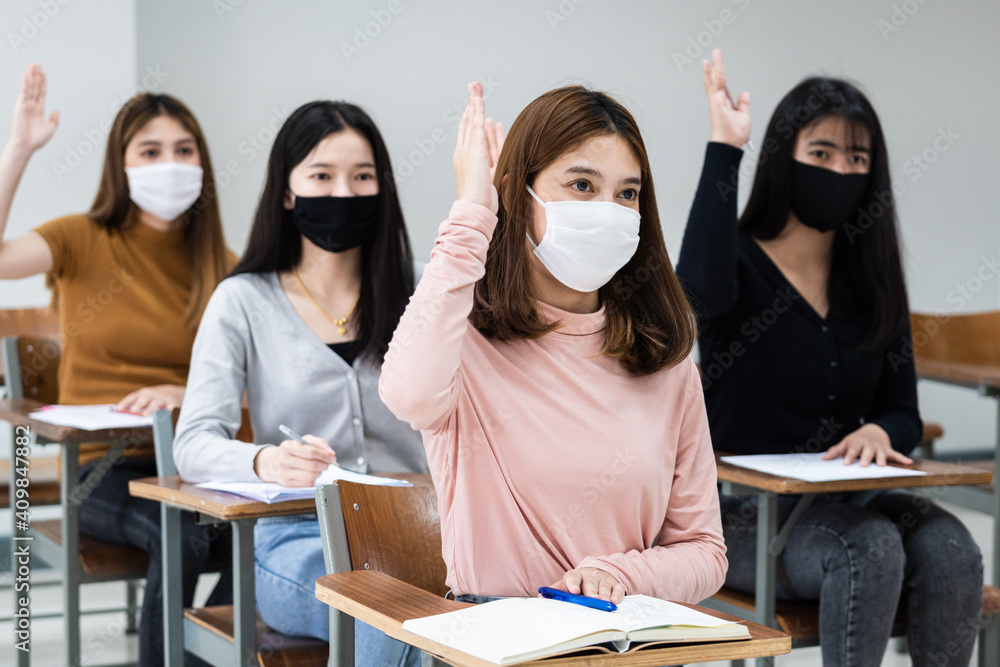 Female teenager college students wears face mask and keep distance ...