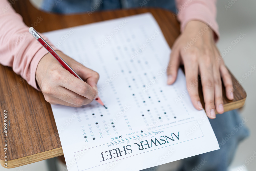 Close up of young female university students concentrate on doing ...