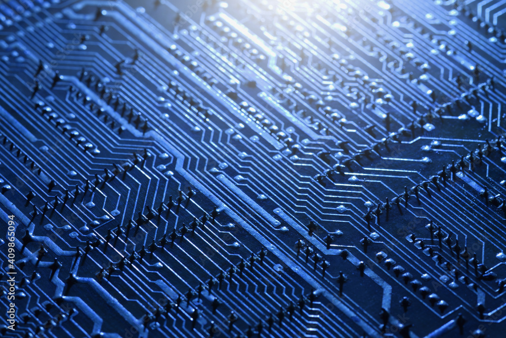 Electronic circuit Board under blue light as the technology background ...