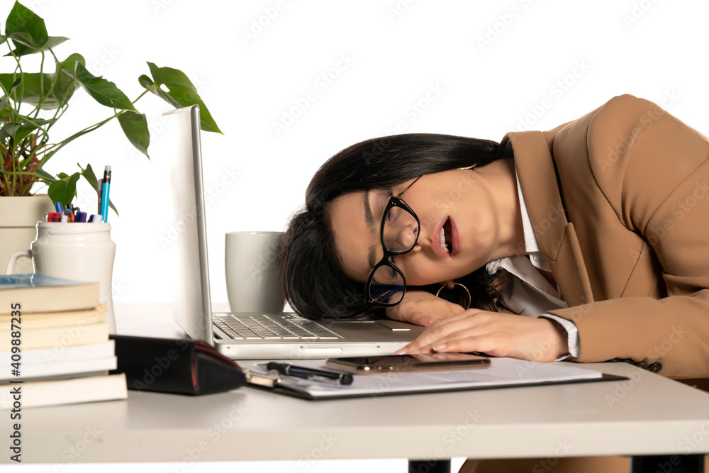 Office woman sleeping on her desk at work. Stock Photo | Adobe Stock