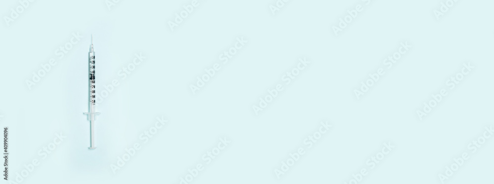 Syringes with blue medicine liquid on an isolated blue solid background ...