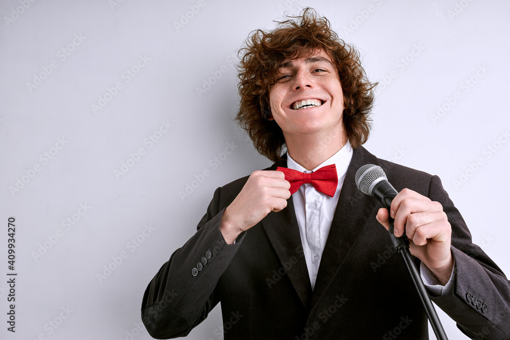 successful speaker man with microphone speaking on stage, have a good ...