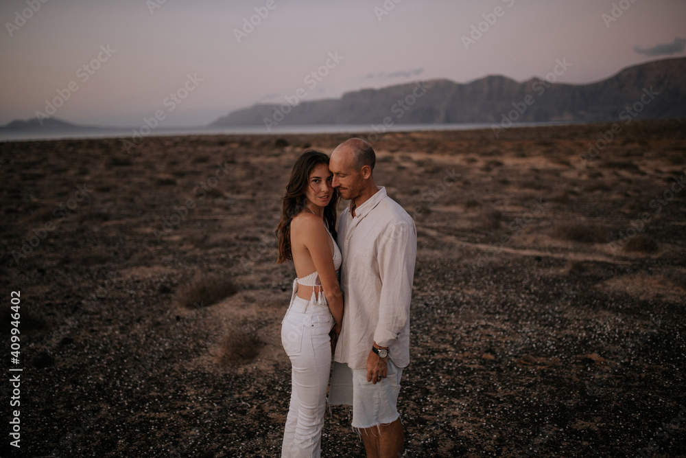 Side view of peaceful couple in white outfit standing together in ...