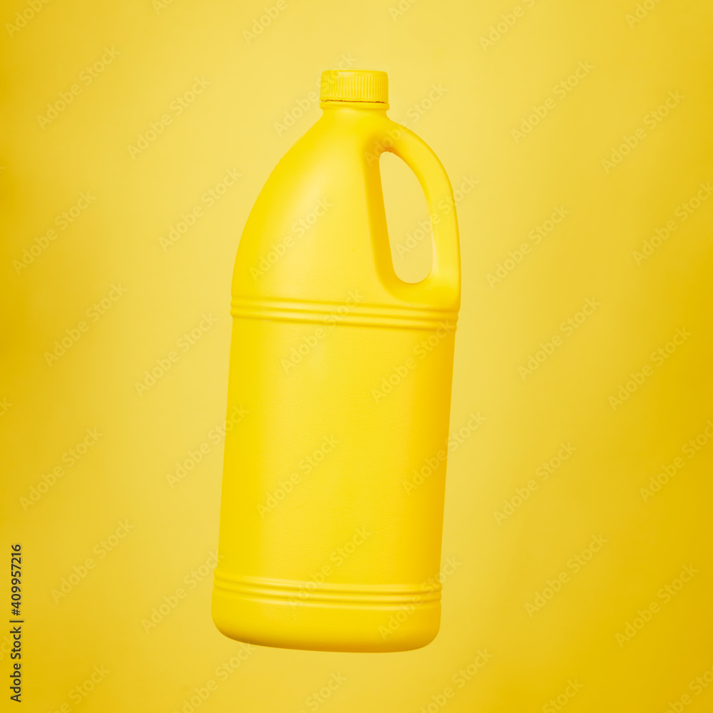 Bright plastic container from liquid detergent placed on vivid yellow ...