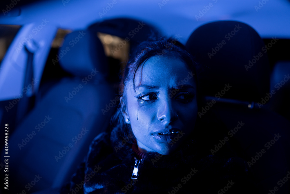 Side view of unhappy young female thinking about problems and crying ...