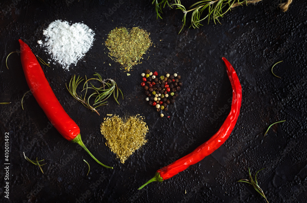 Spices salt, pepper, dill, parsley, rosemary are poured in the shape of ...