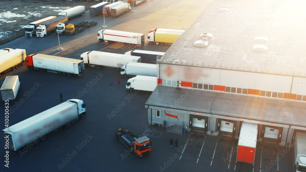Semi-trailers trucks stand at the warehouse ramps for load and unload ...
