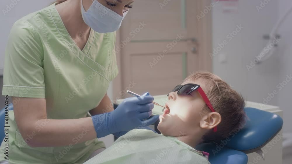 Lovely female doctor is touching a medical light bulb. Works with a ...