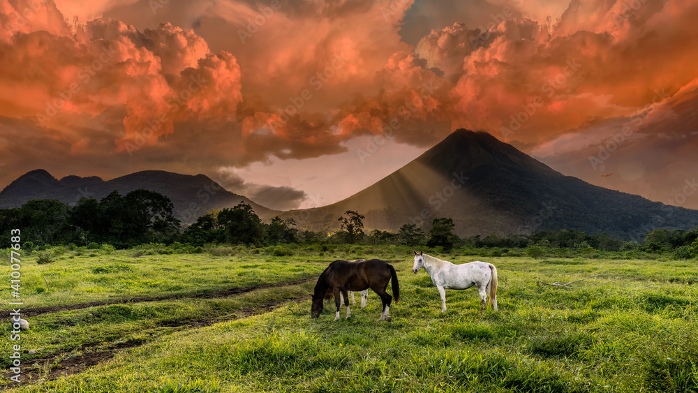 Volcan Arenal dominates the landscape during sunset, as seen from the ...