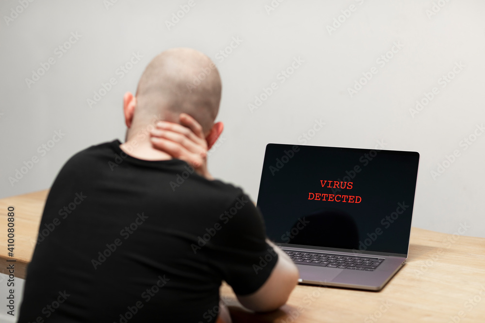 Foto de Virus detected with a warning sign in red on a laptop. A ...
