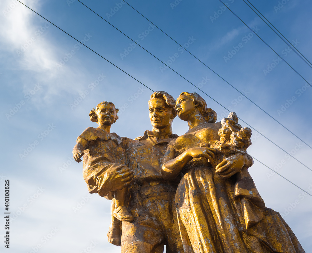 An old monument of the Soviet era symbolizing a happy Soviet family, as ...