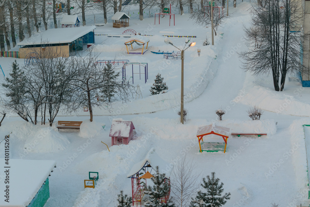 Children's playgrounds in winter. Miniature buildings and structures ...