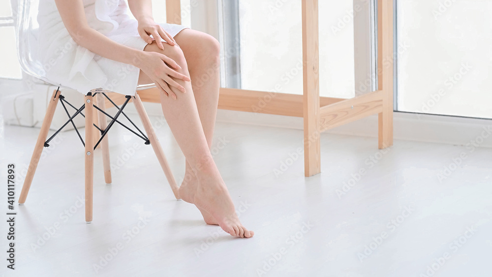 woman touch her smooth and soft skin on legs, enjoy beauty procedures ...