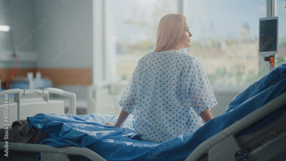 Hospital Ward: Beautiful Caucasian Female Patient Sitting on a Bed ...