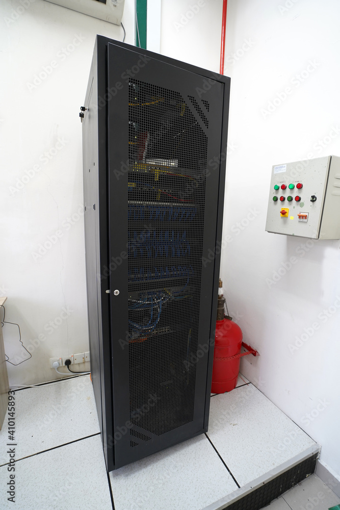 Black tall server rack inside a server room. Stock Photo | Adobe Stock