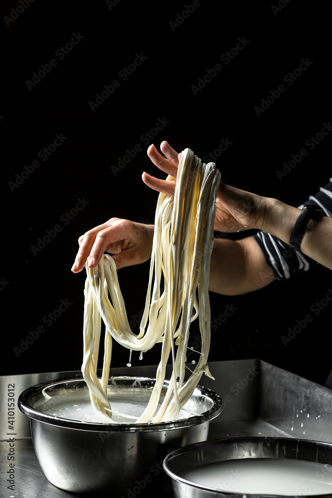 A cheesemaker prepares a form of mozzarella cheese silano or ... A cheesemaker prepares a form of mozzarella cheese silano or ...