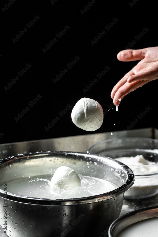 Production process of mozzarella cheese. woman working in a small ...