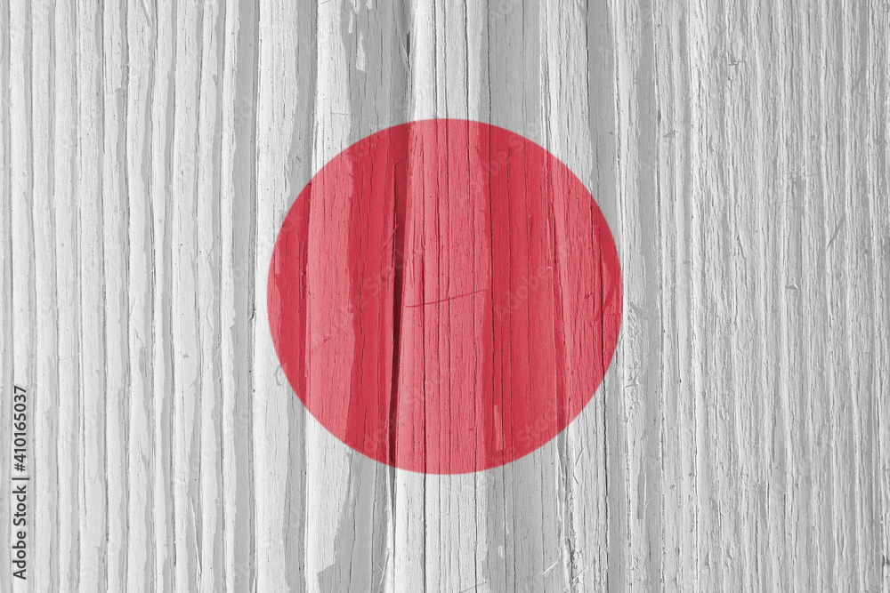 The flag of Japan on a dry wooden surface, cracked with age. Light pale ...