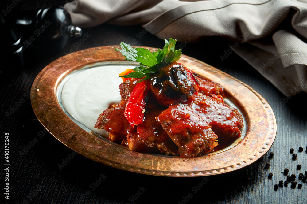Iskender kebab prepared from thinly cut grilled lamb topped with hot ...