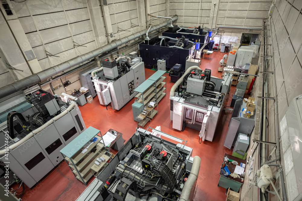 general view of the shop of a metalworking plant with cnc machines ...