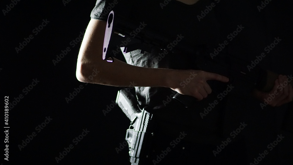 Abstract Woman openly carrying an AR15 rifle and a .45 caliber pistol ...