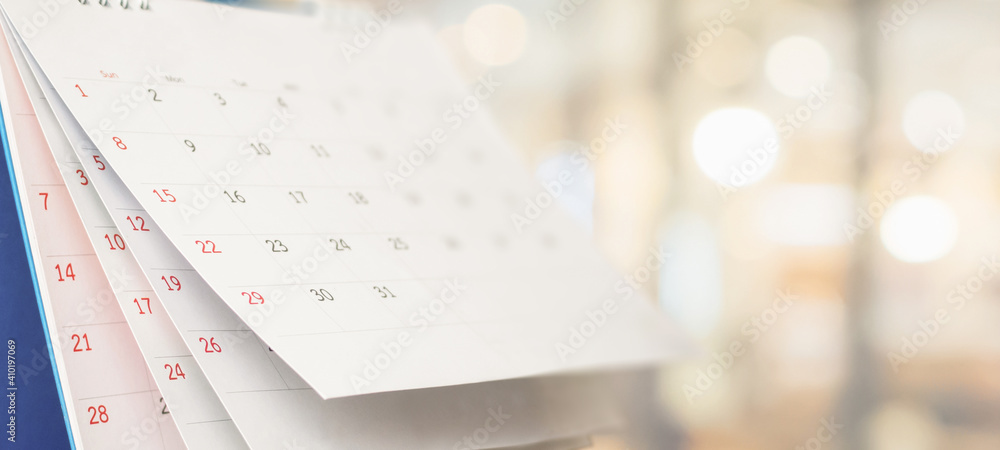Close up white paper desk calendar with blurred bokeh background ...