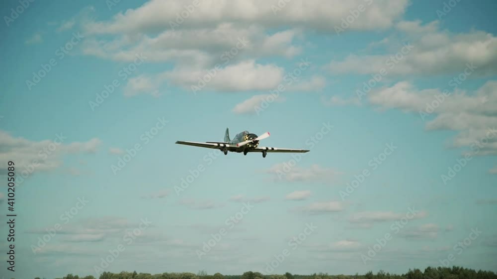 old retro single-engine propeller airplane dives and attacks the enemy ...