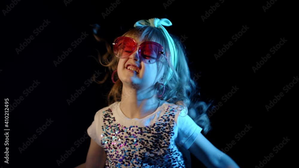 Futuristic hipster teen girl listening to music, dancing, making faces ...