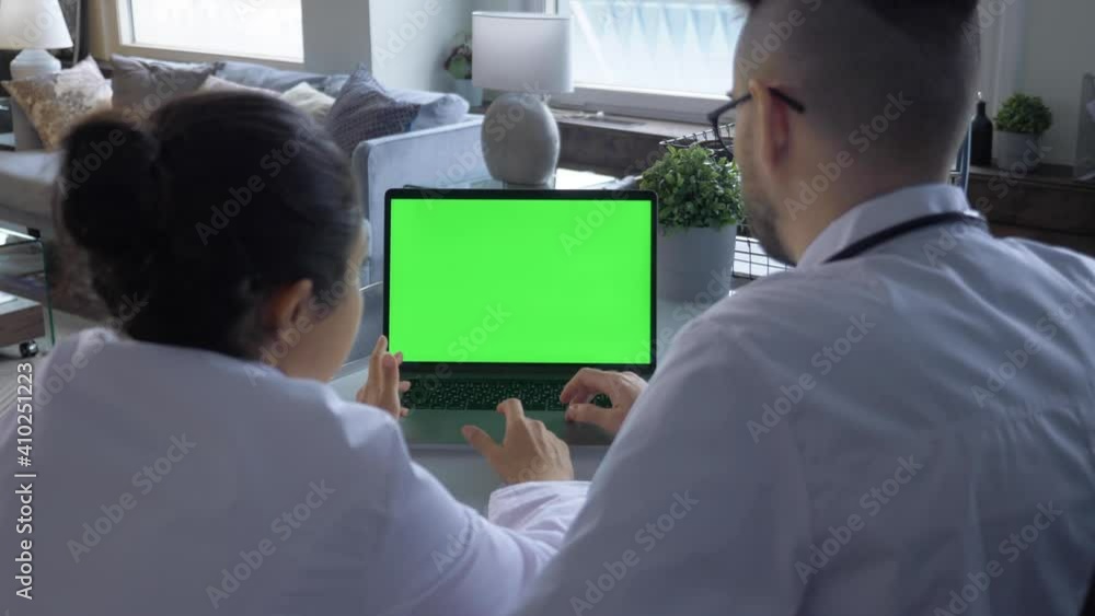 Two medical research scientists looking at green screen in the modern ...