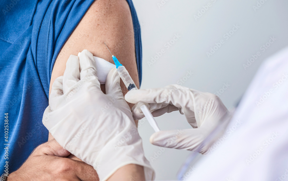 Close-up image of man receiving injection of vaccine Stock Photo ...