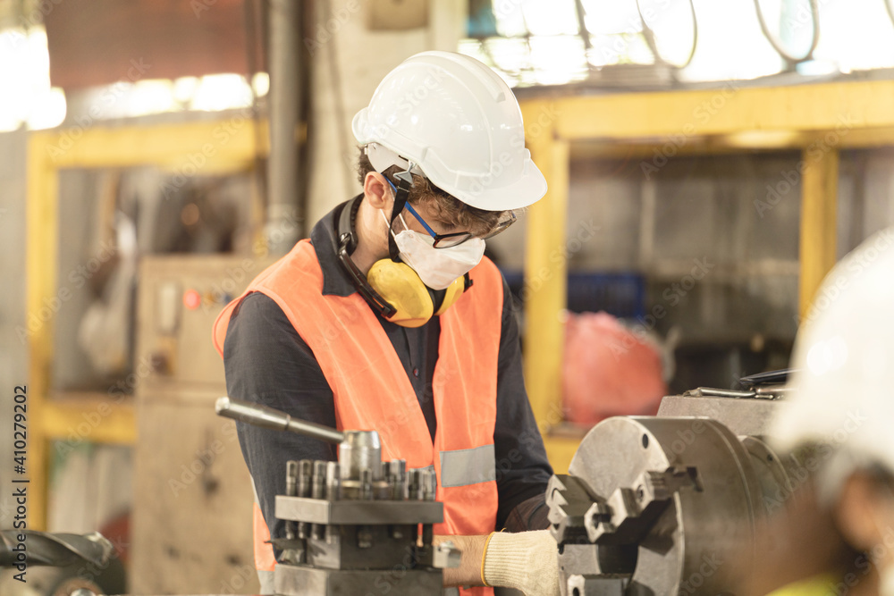 workers factory man wearing face mask and working at heavy machine ...
