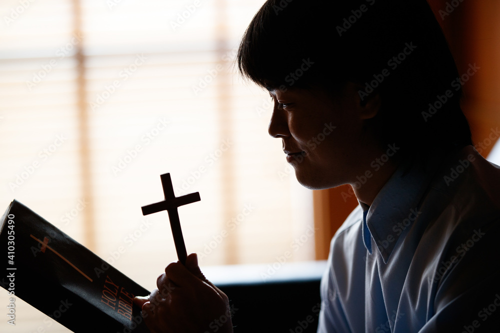 Image is Silhouette. Close up cross and bible. Asian Man praying for ...
