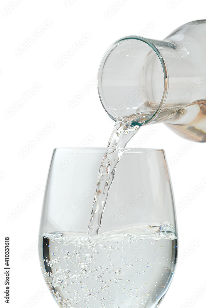 Pouring water. pouring drinking water from a glass decanter to glass ...