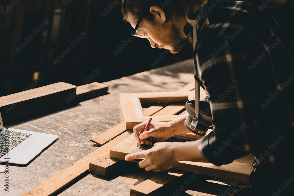 Carpenter man woodcraft working in furniture wood workshop with ...