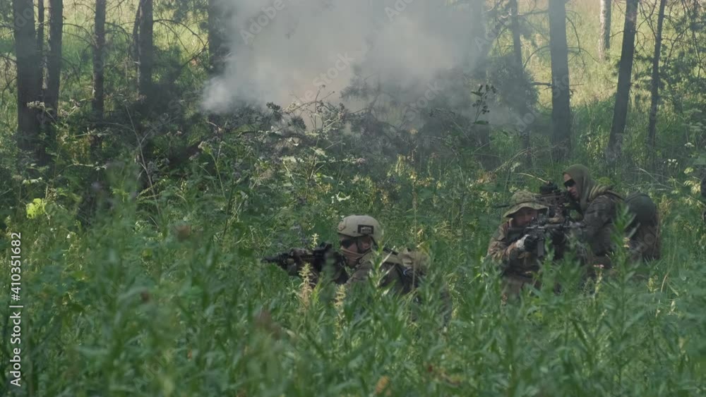 Wide shot of unrecognizable armed soldiers in camouflage clothing ...