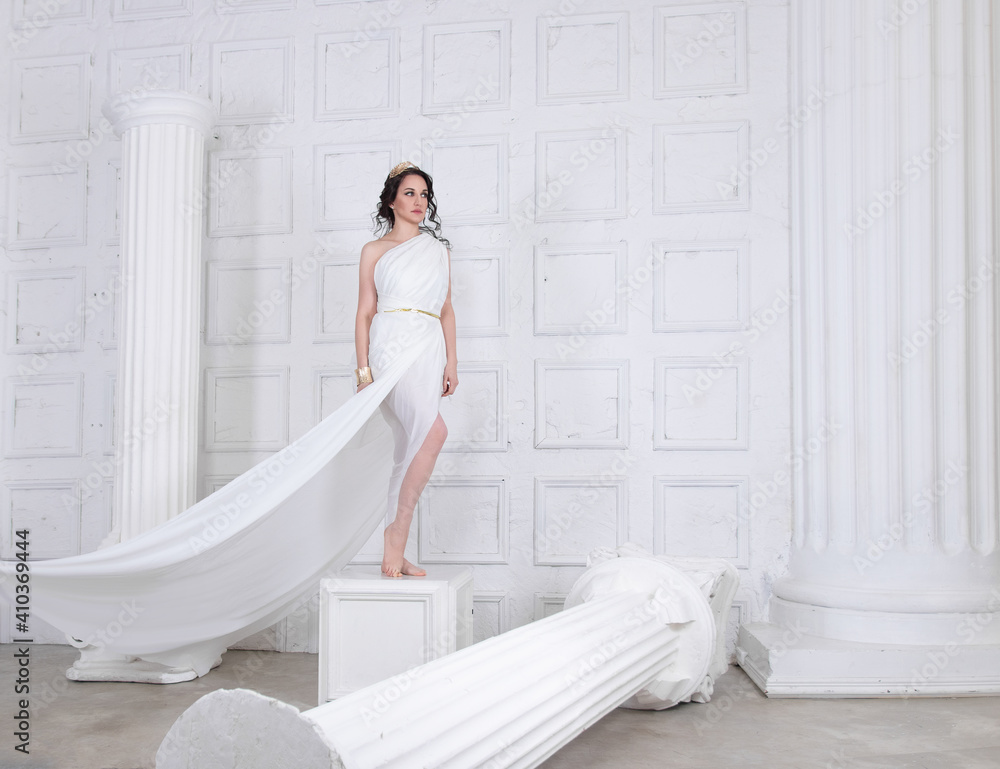 Beautiful Greek goddess woman close up among the white ancient ruins ...