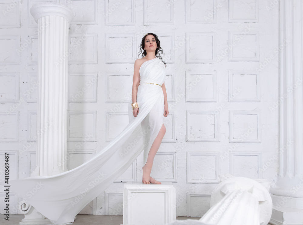 Beautiful Greek goddess woman close up among the white ancient ruins ...