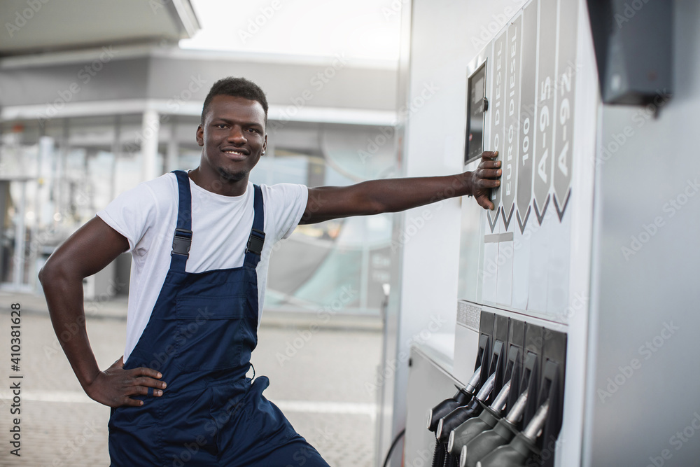 Handsome young smiling black gas station worker on white t-shirt and ...