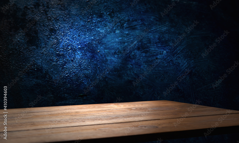 dark blue background, dark wall background. Empty workplace in front of ...