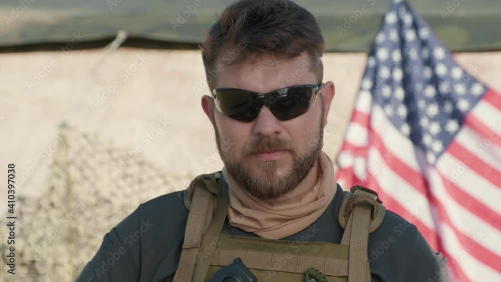 Tilting-up slow-motion close up portrait of brutal military man from US ...