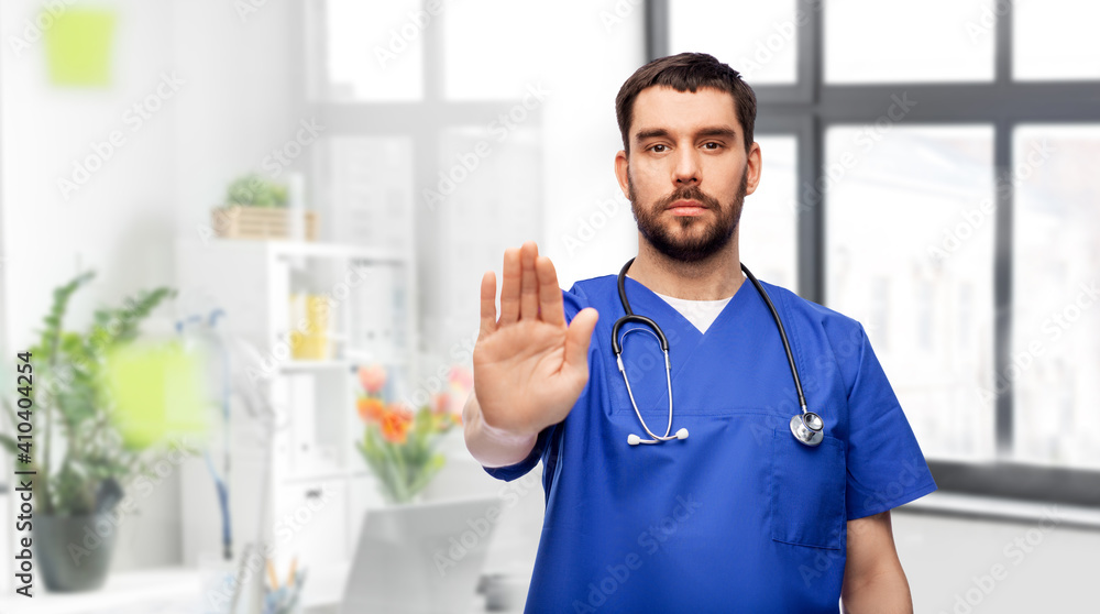 healthcare, profession and medicine concept - male doctor in blue ...